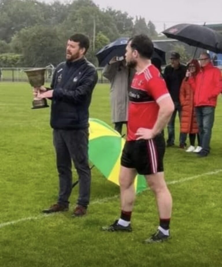 Adare Senior Football team captain Eoghan Costelloe receives the West ...